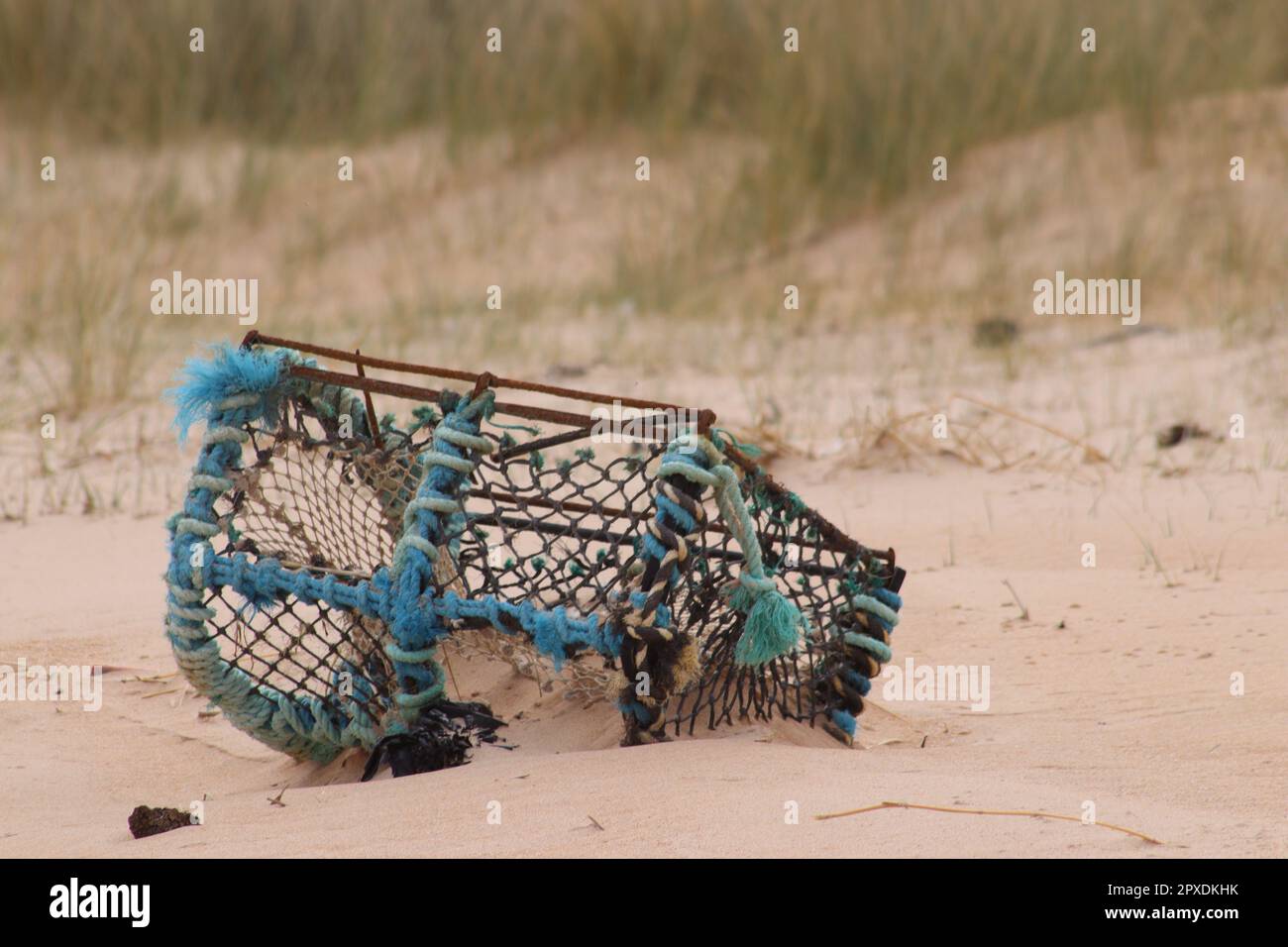 Lobster pots and nets washed up on beach Stock Photo - Alamy