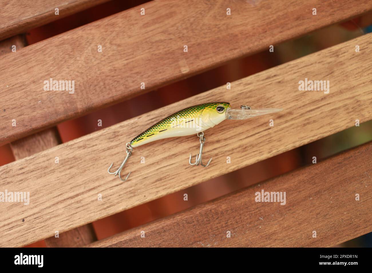 artificial small fish with sharp fishing hooks is a wobbler for ...