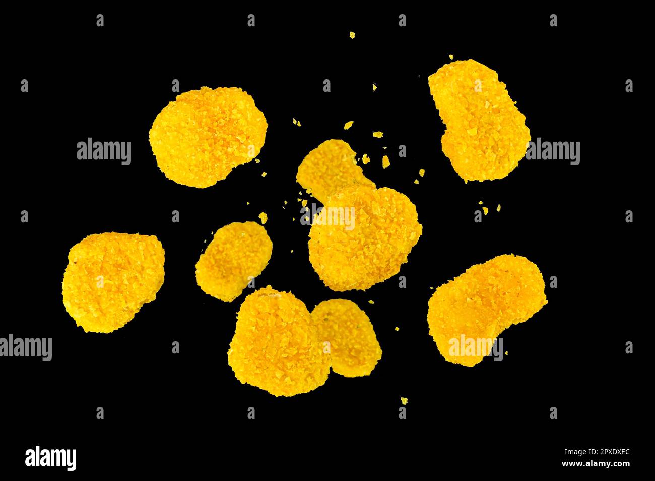 Falling nuggets isolated on a black background, selective focus. Fresh ...