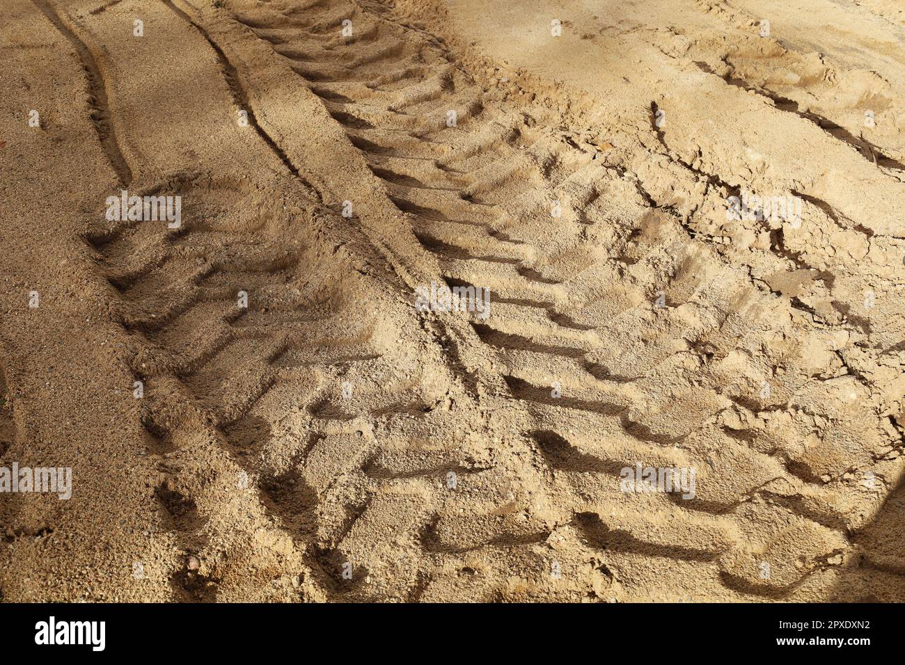 Detail of a off-road tire print in the sandy road . Close up of tracks ...