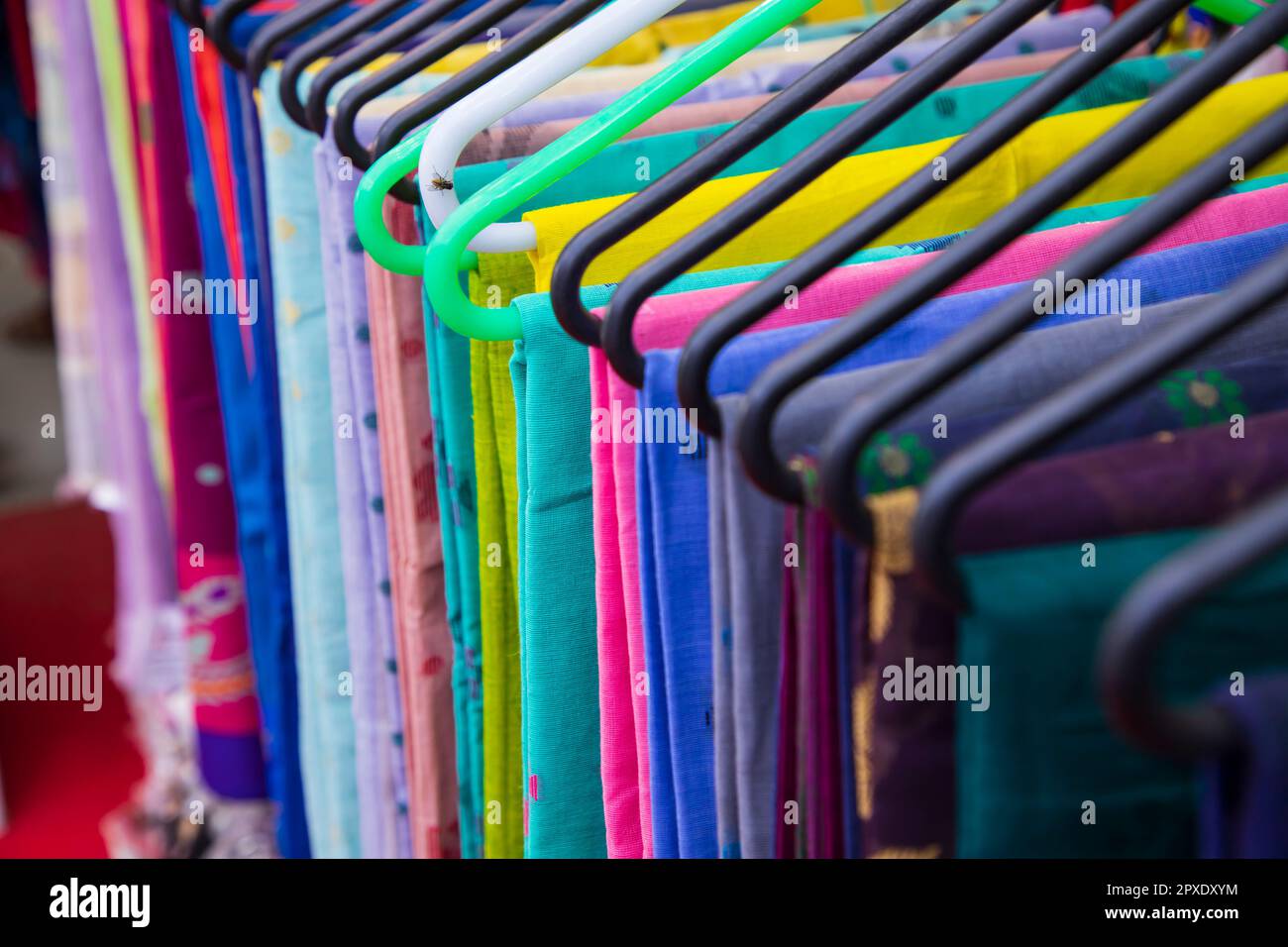 Colorful Saree clothes on hangers in a shop. Selective focus Stock ...