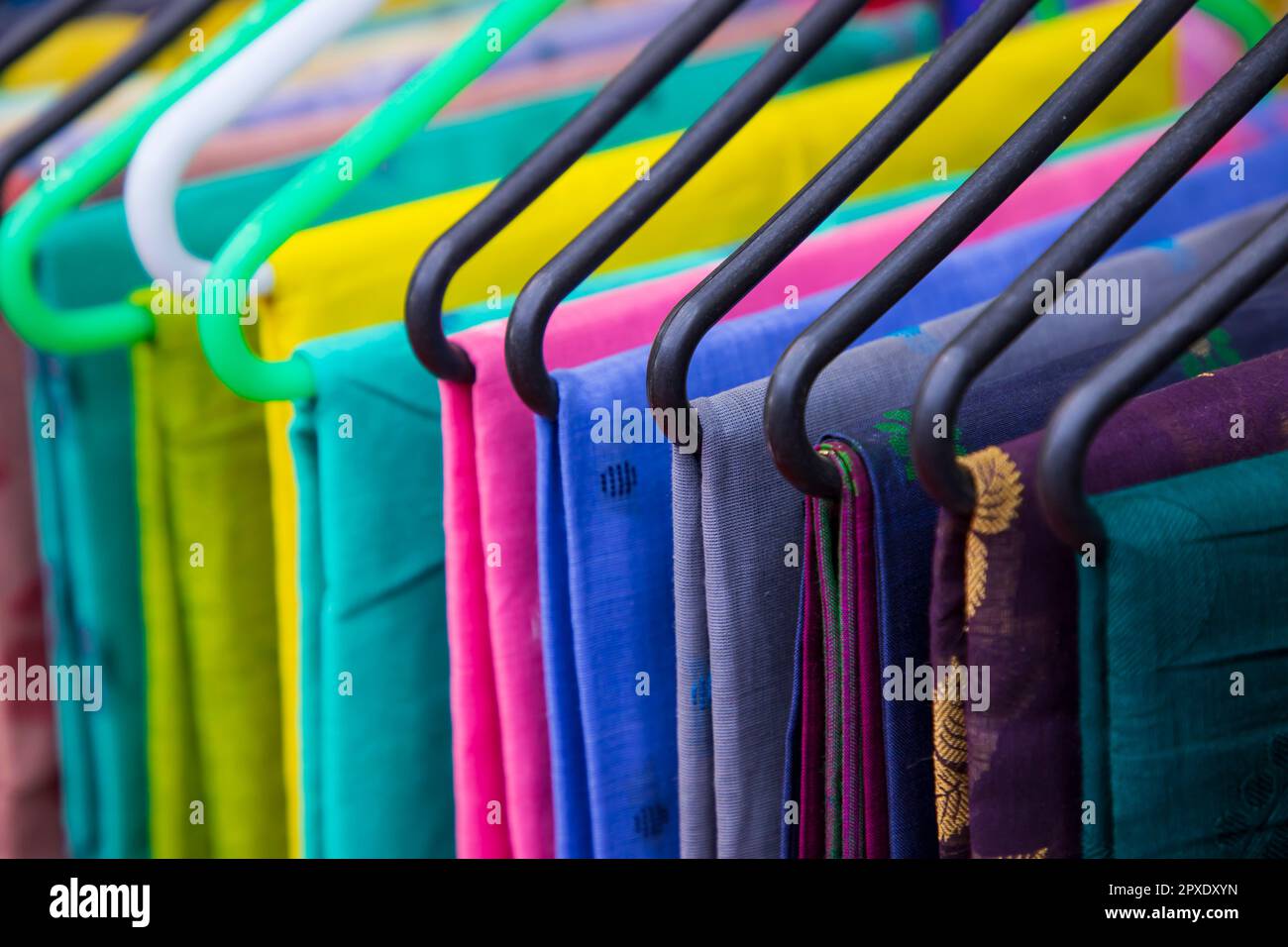 Colorful Saree clothes on hangers in a shop. Selective focus Stock ...
