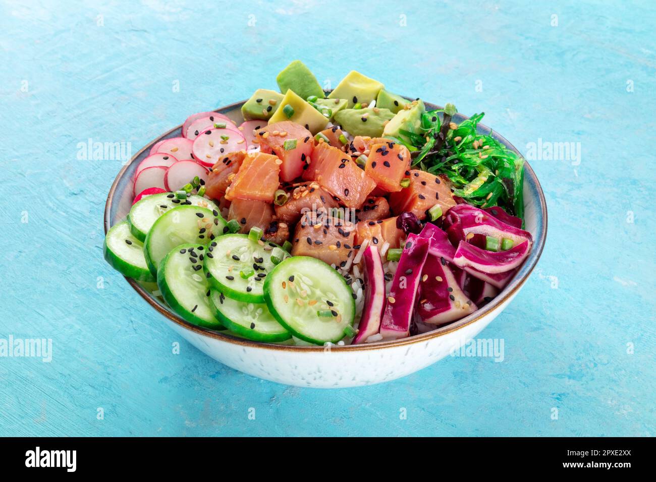 Tuna poke bowl with avocado, cucumbers, wakame, radish, and purple ...