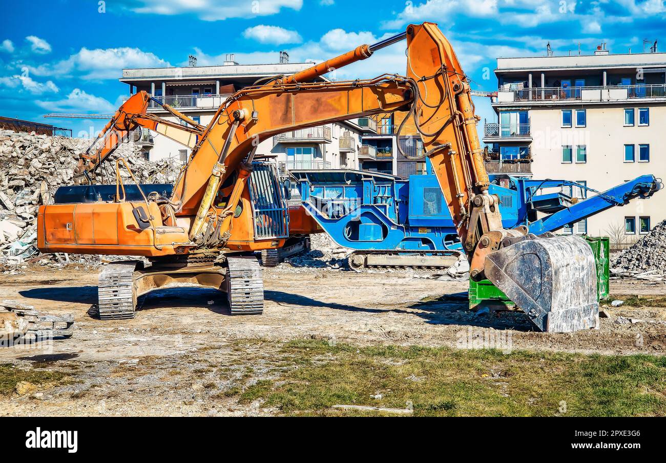 Orange Excavator at construction site Stock Photo - Alamy