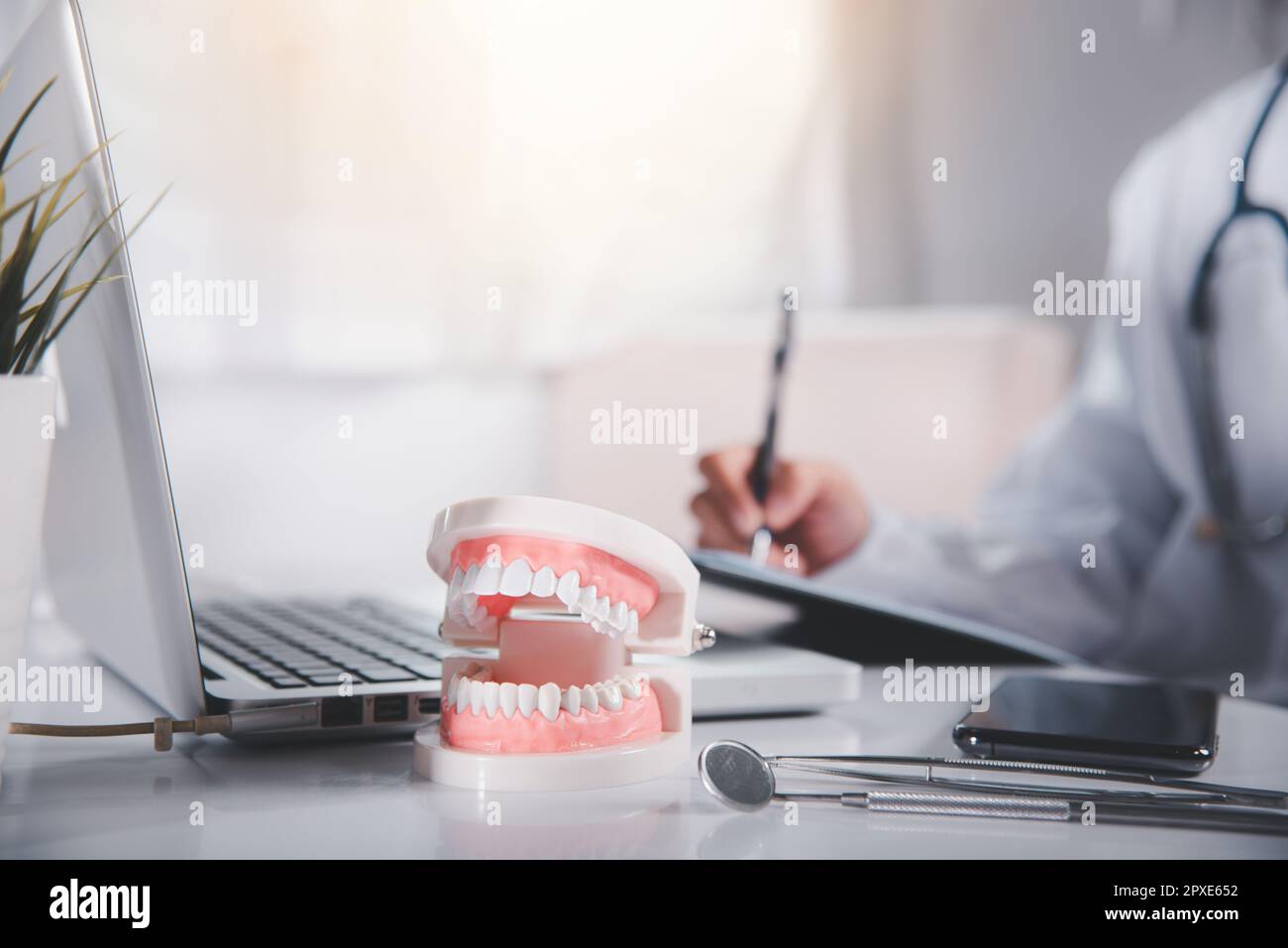 Oral dental. Dentist doctor in uniform writing information of patient ...