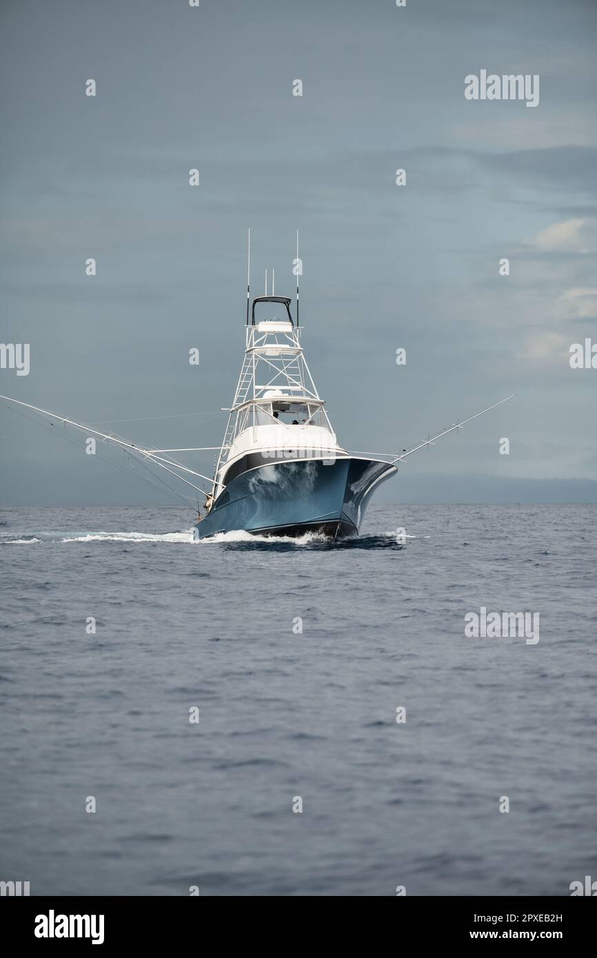 A view of a sport fishing boat in the ocean with a blue hull Stock ...