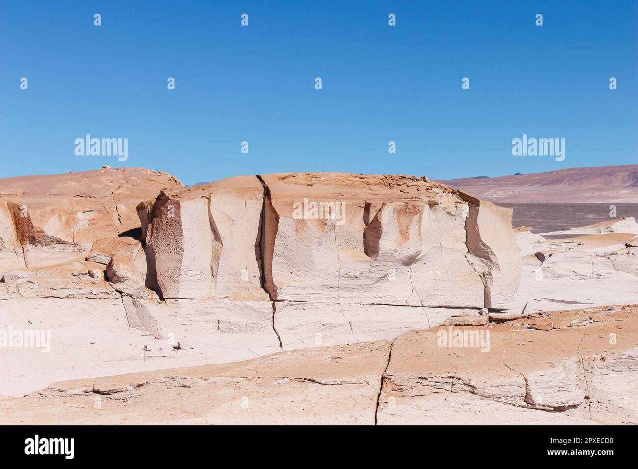 A scenic view of a desert terrain with huge white volcanic stones at ...