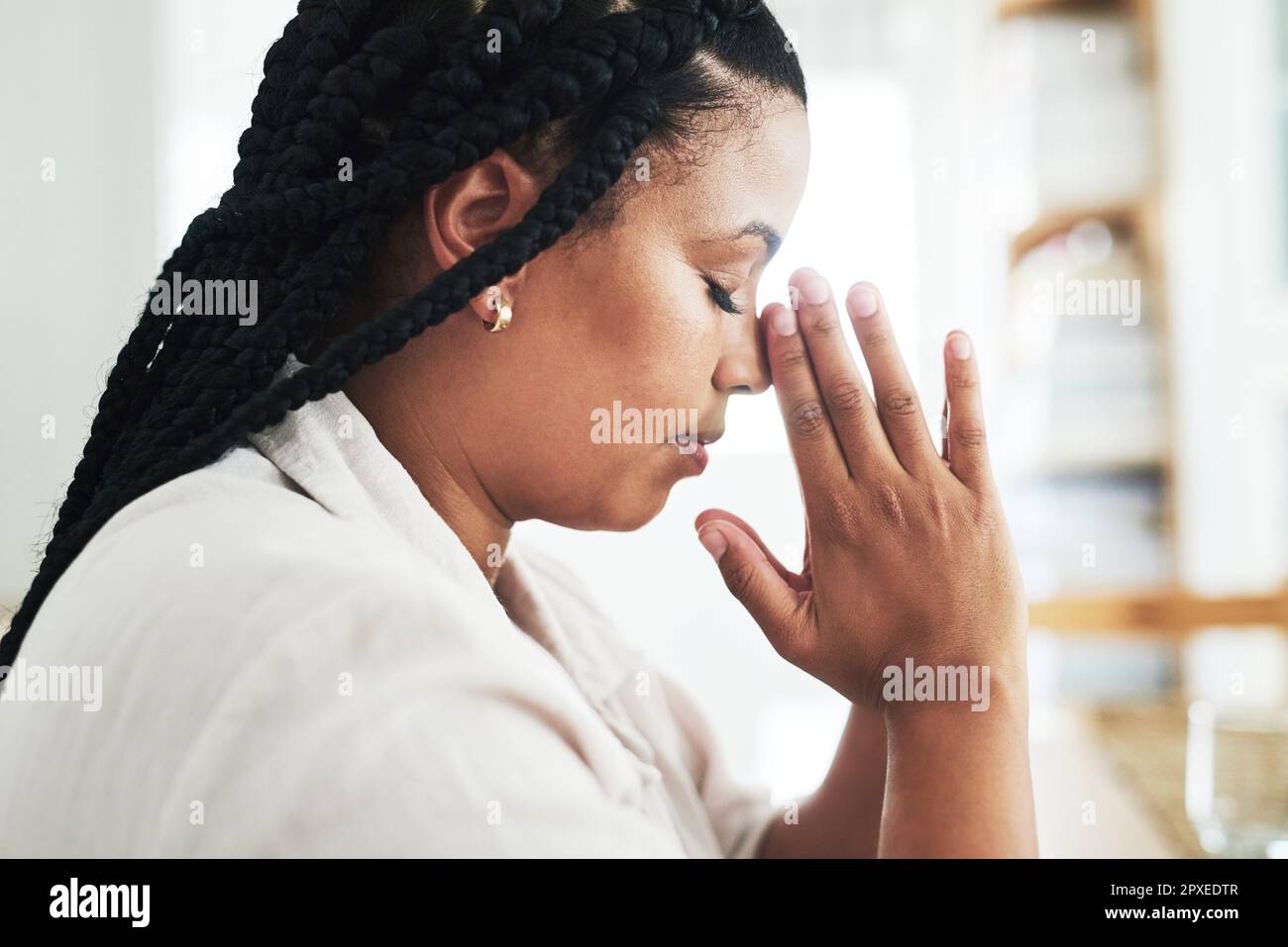 True prayer is a way of life. a young woman praying at home Stock Photo - Alamy