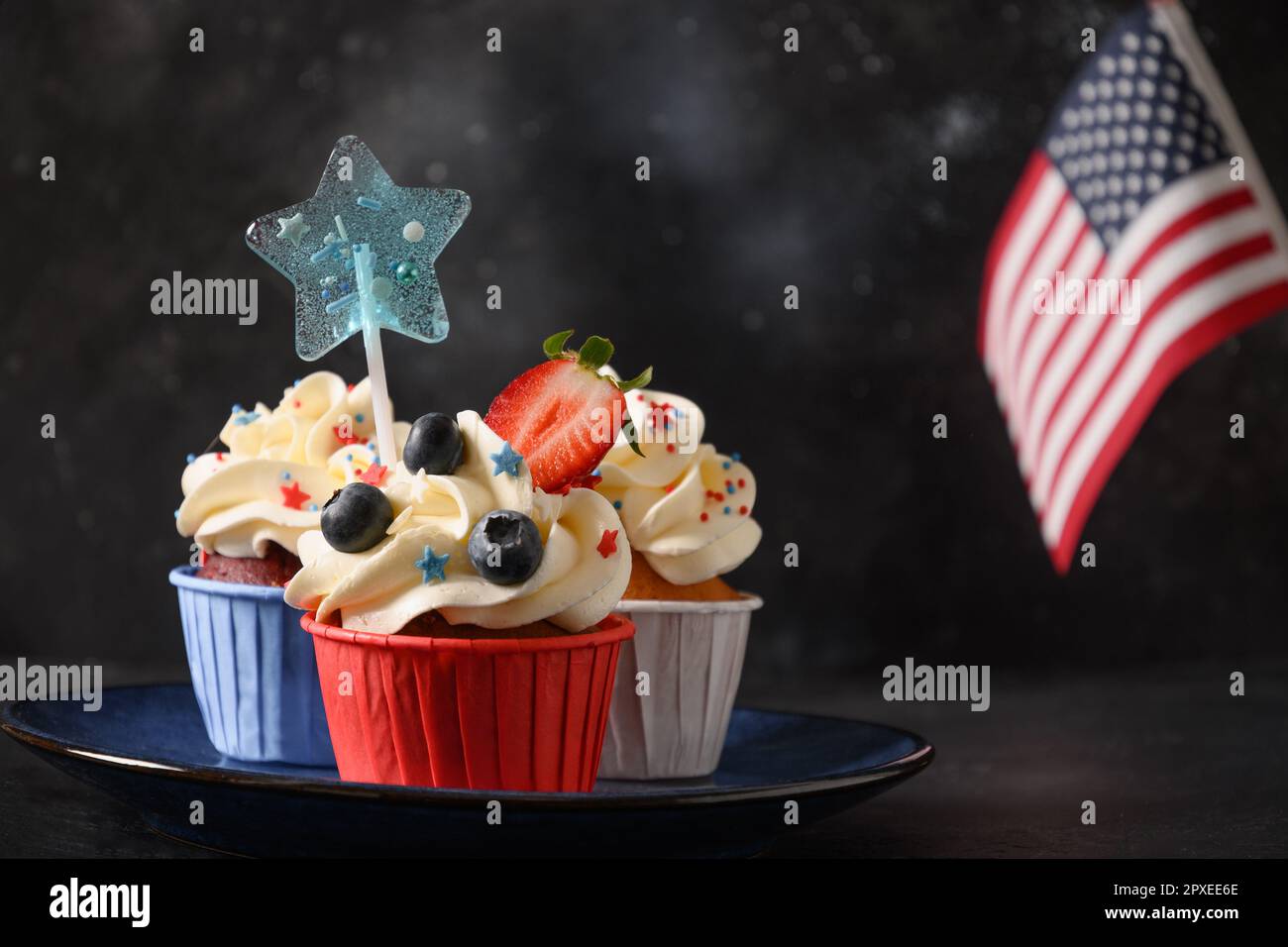 Traditional American vanilla three cupcakes with festive decorations ...