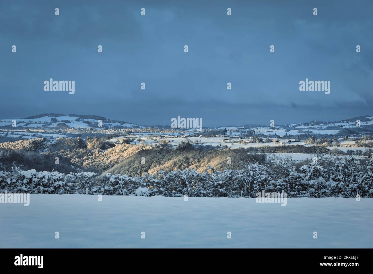 An aerial view of a snow-covered mountainous landscape, with the night ...