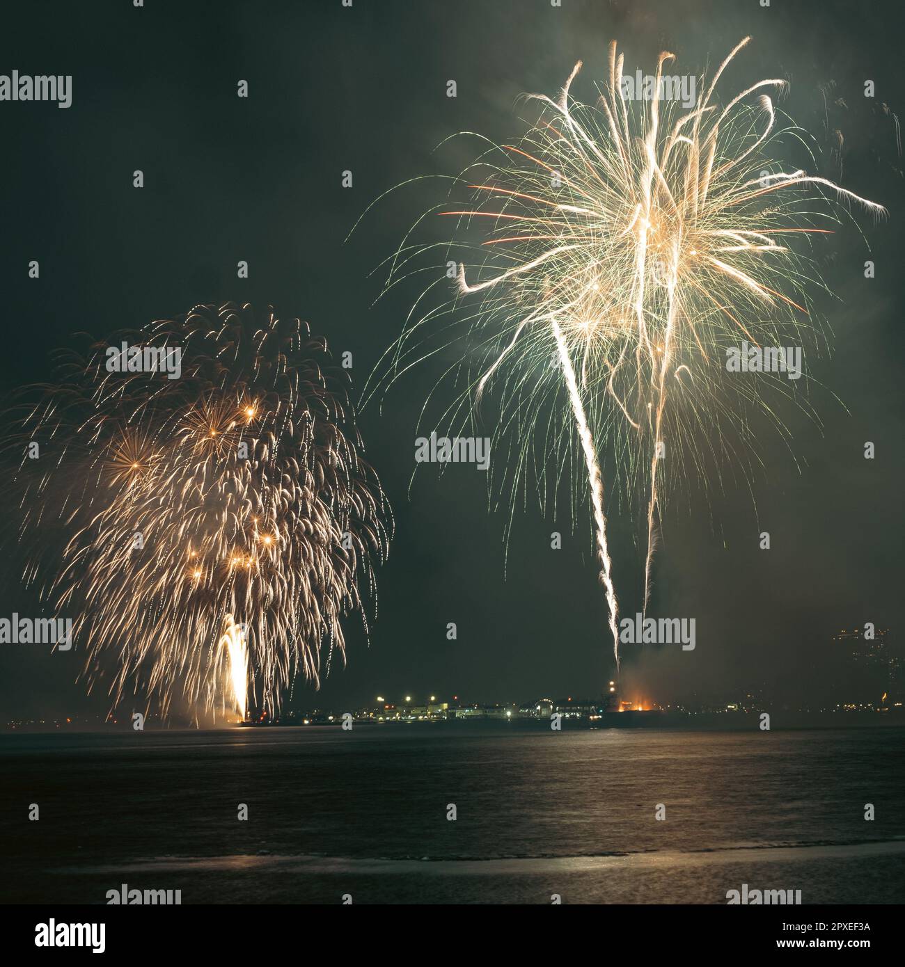 A vibrant display of fireworks bursting in the night sky above a ...