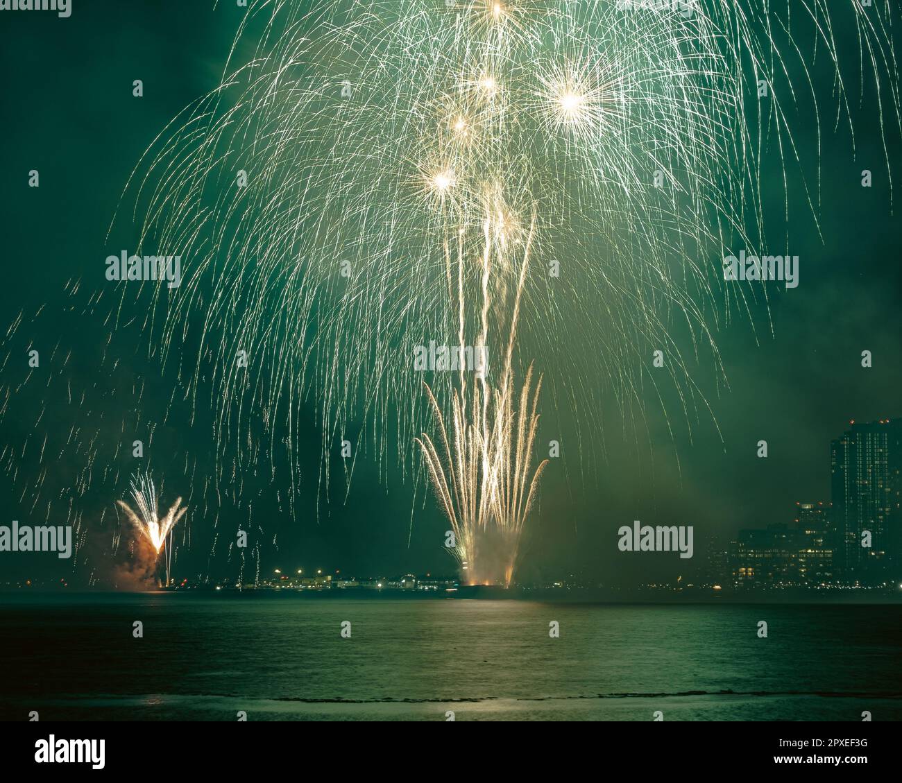 A vibrant display of fireworks bursting in the night sky above a ...
