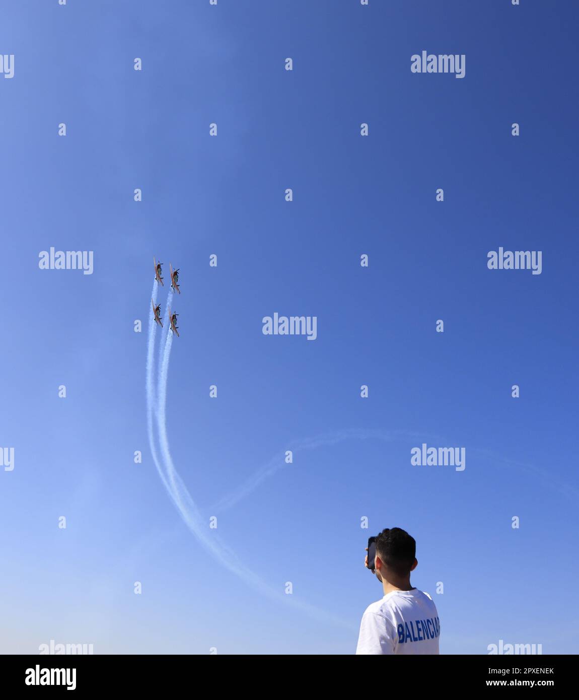 A Caucasian young adult is taking a photograph of military aircrafts in ...