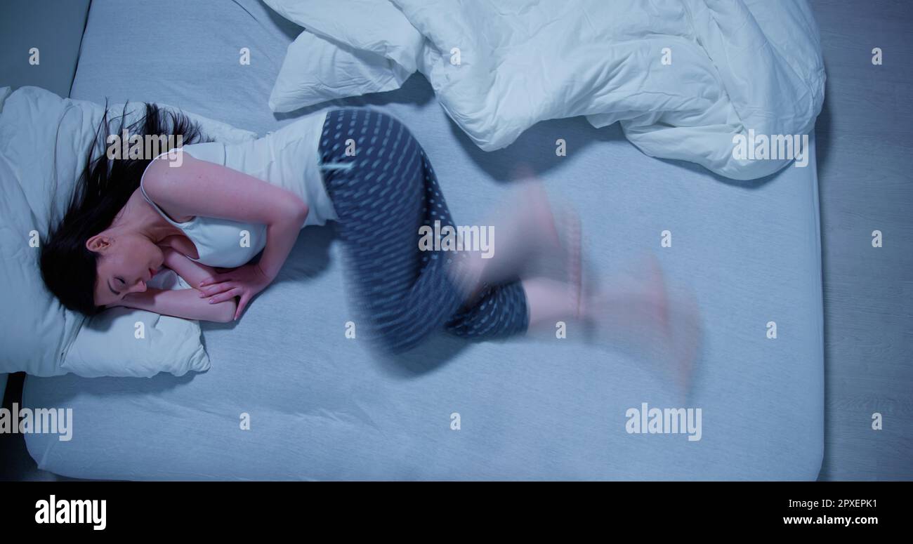 Woman With RLS - Restless Legs Syndrome. Sleeping In Bed Stock Photo ...