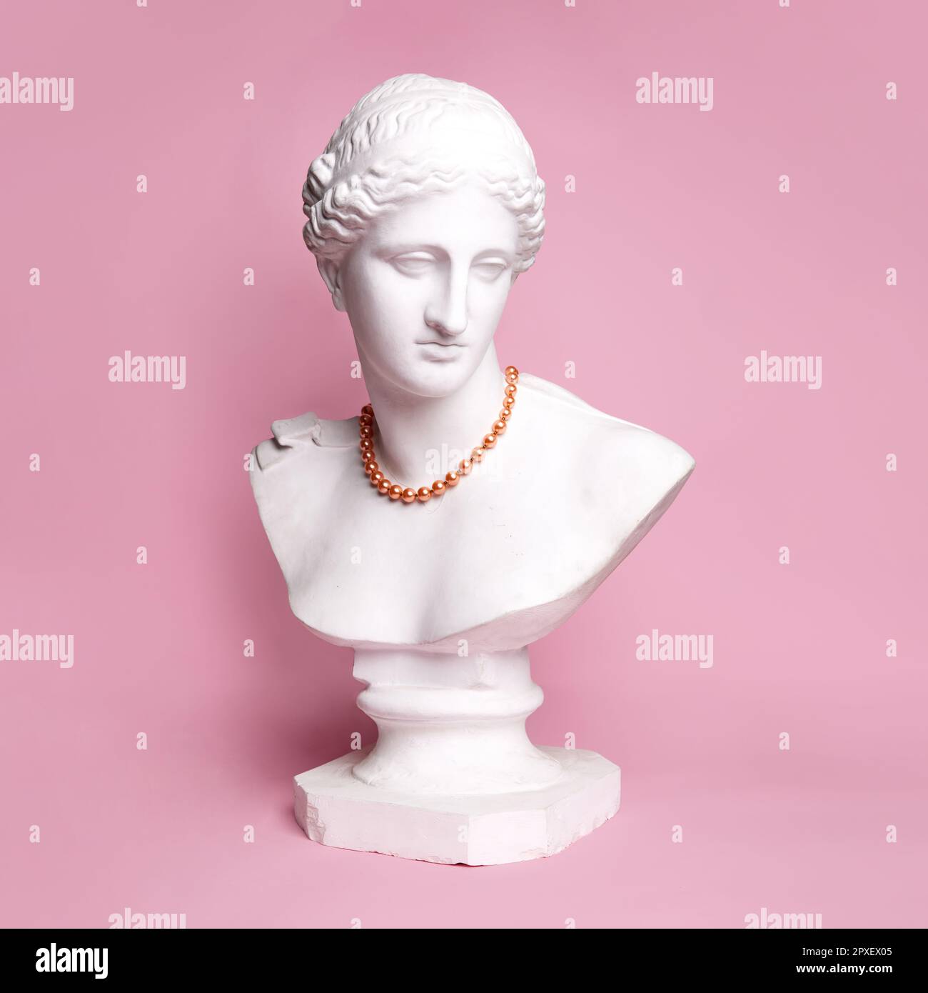 Antique statue bust of pretty woman in red beautiful necklace against ...