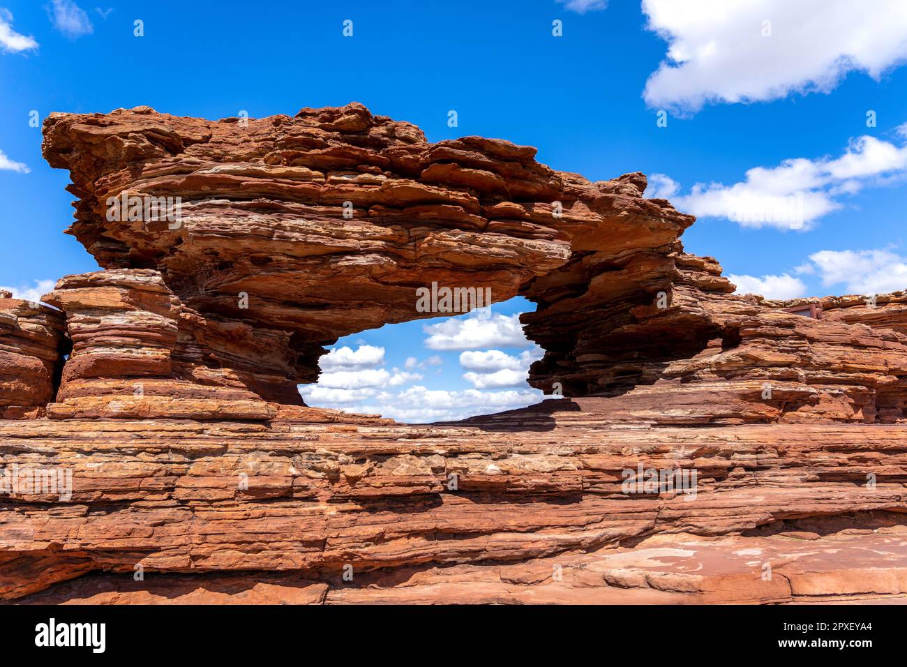 A window-shaped archway cut into a sandstone rock formation in Kalbarri ...