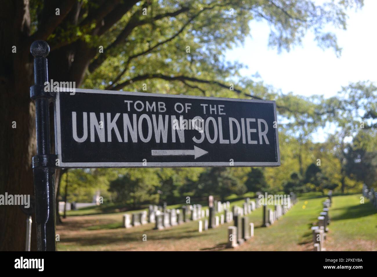 A black and white sign "Tomb of the Unknown Soldier" placed next to a ...