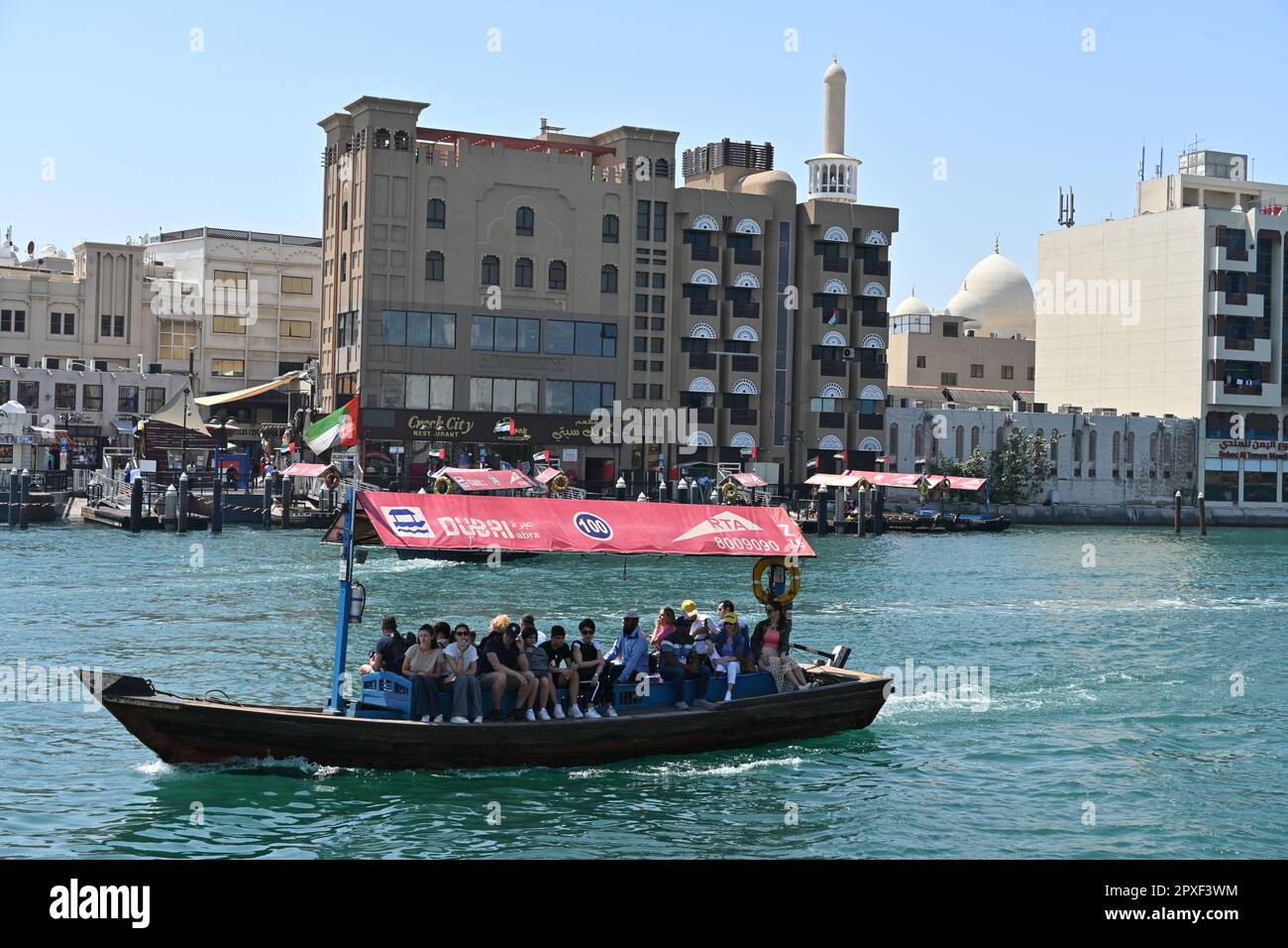 View of Dubai creek with "abra" boat, traditional water taxis in Deira ...