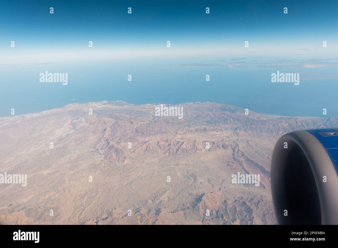 view from the aeroplane window of the barren desert landscape of the ...