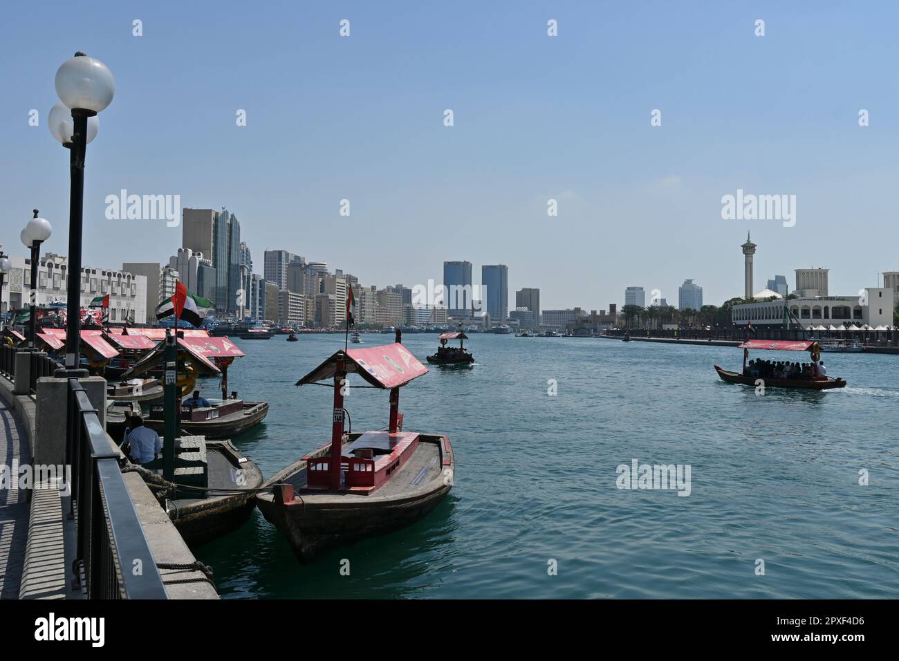 View of Dubai creek with "abra" boat, traditional water taxis in Deira ...