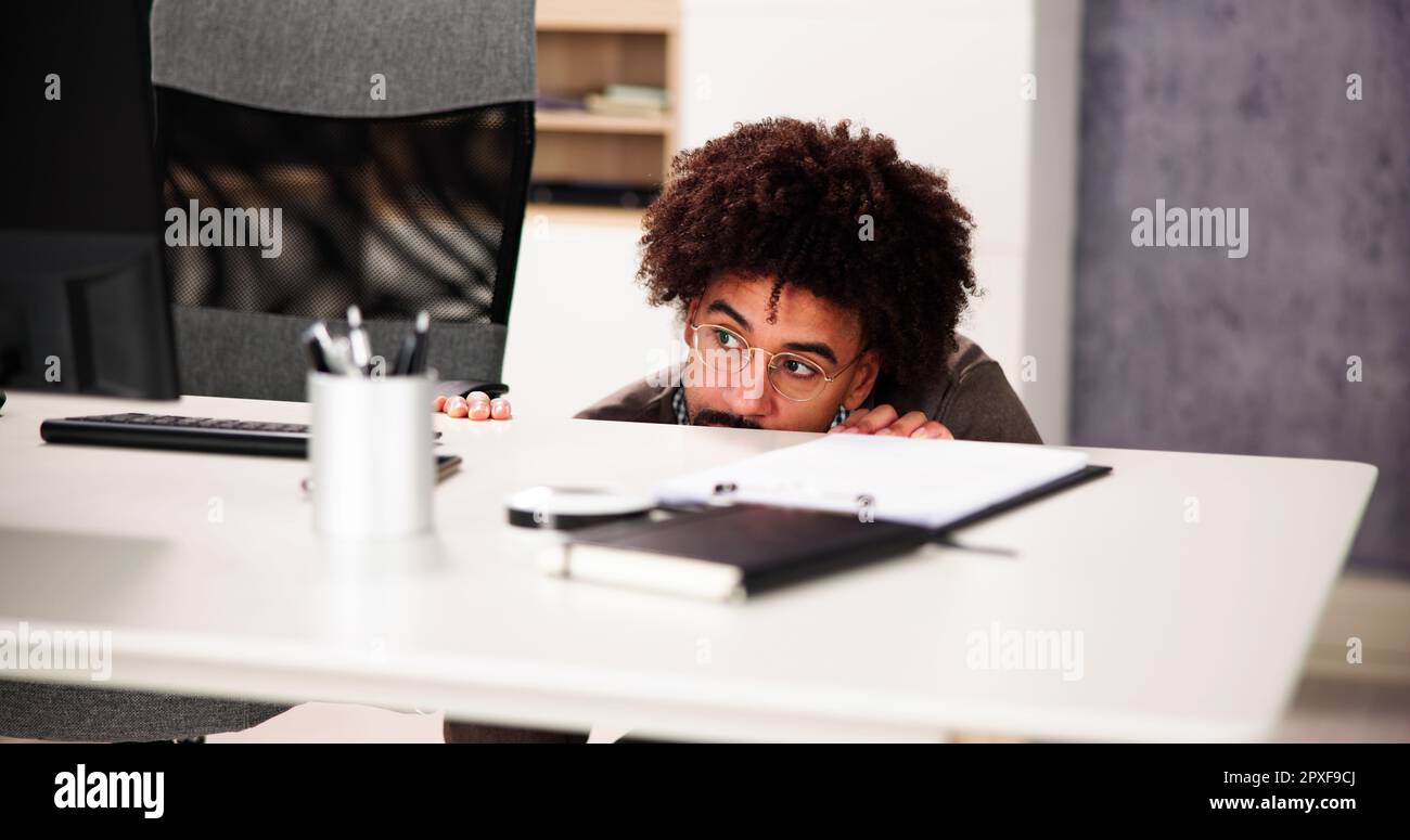 Hiding from the boss hi-res stock photography and images - Alamy