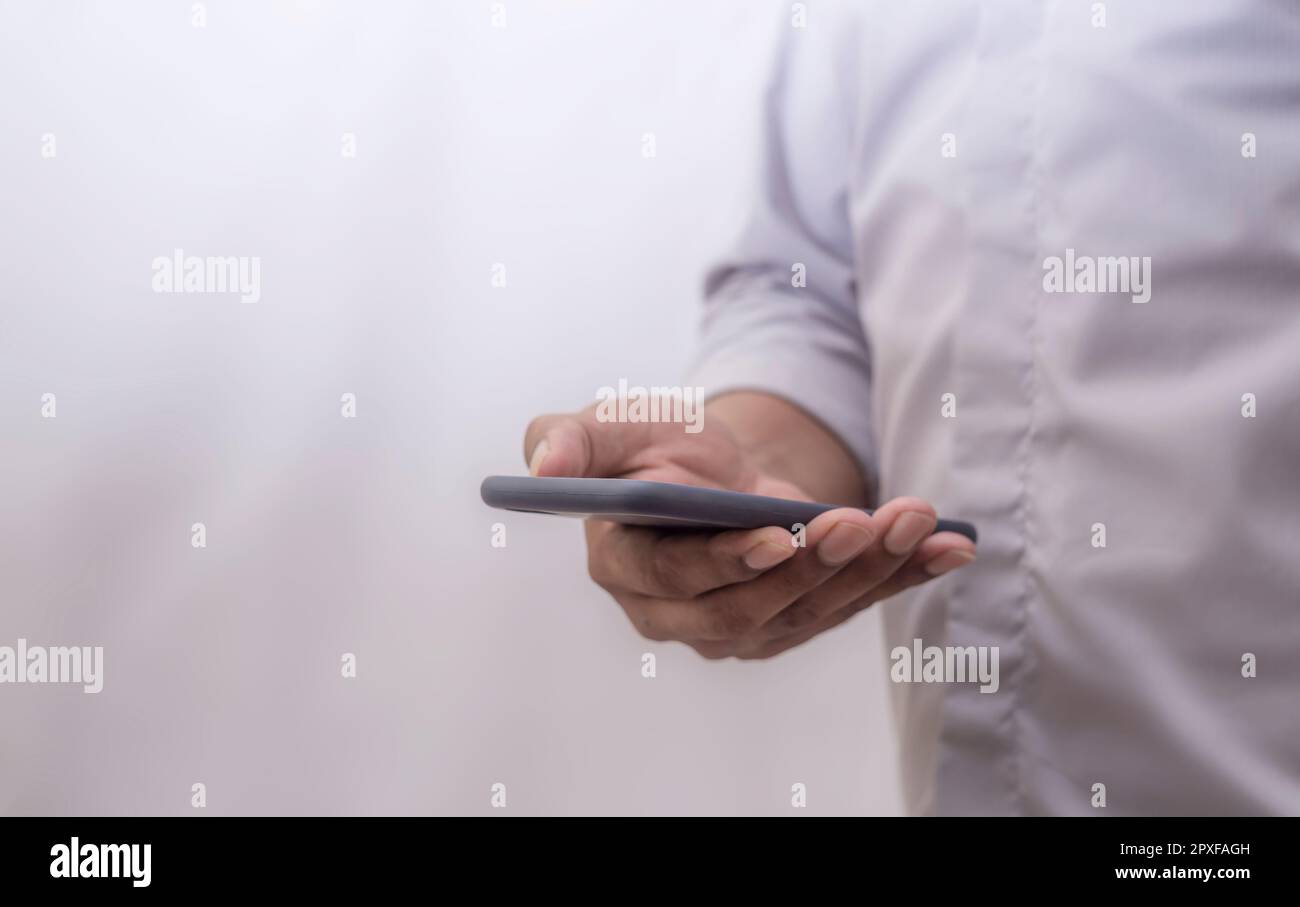 Human using smart phone mobile on blurred background Stock Photo - Alamy
