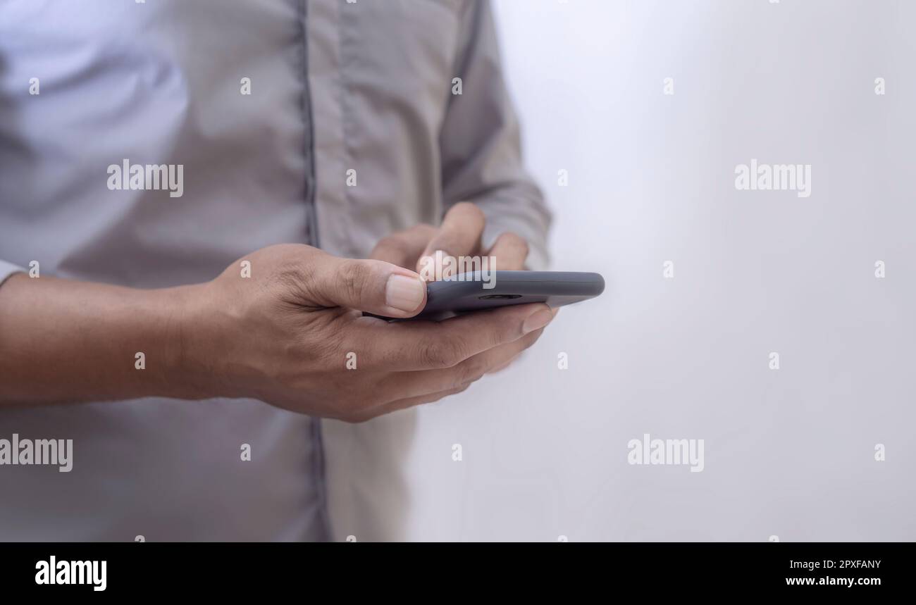 Human using smart phone mobile on blurred background Stock Photo - Alamy
