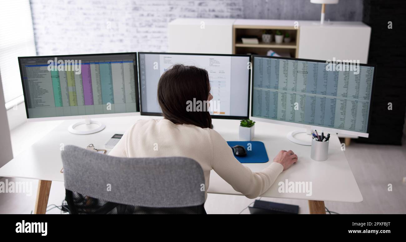 Using Corporate Invoice Spreadsheet On Computer Monitors Stock Photo ...
