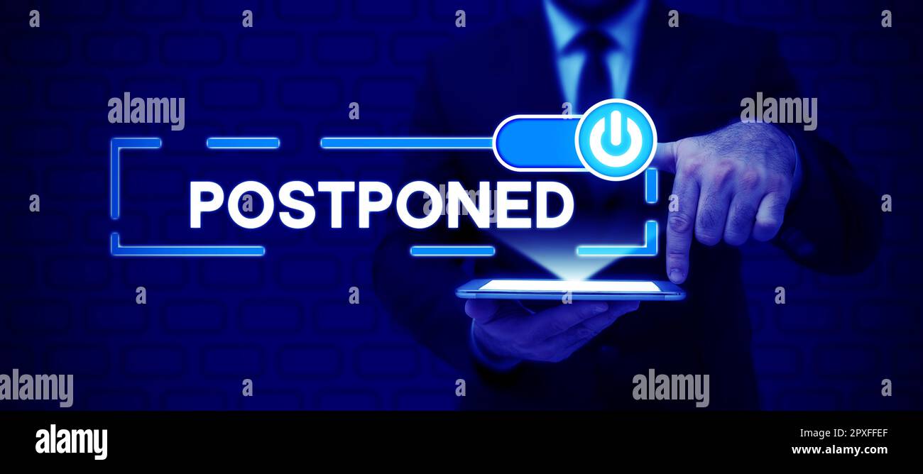 Sign displaying Postponed, Business overview to place later in order of ...