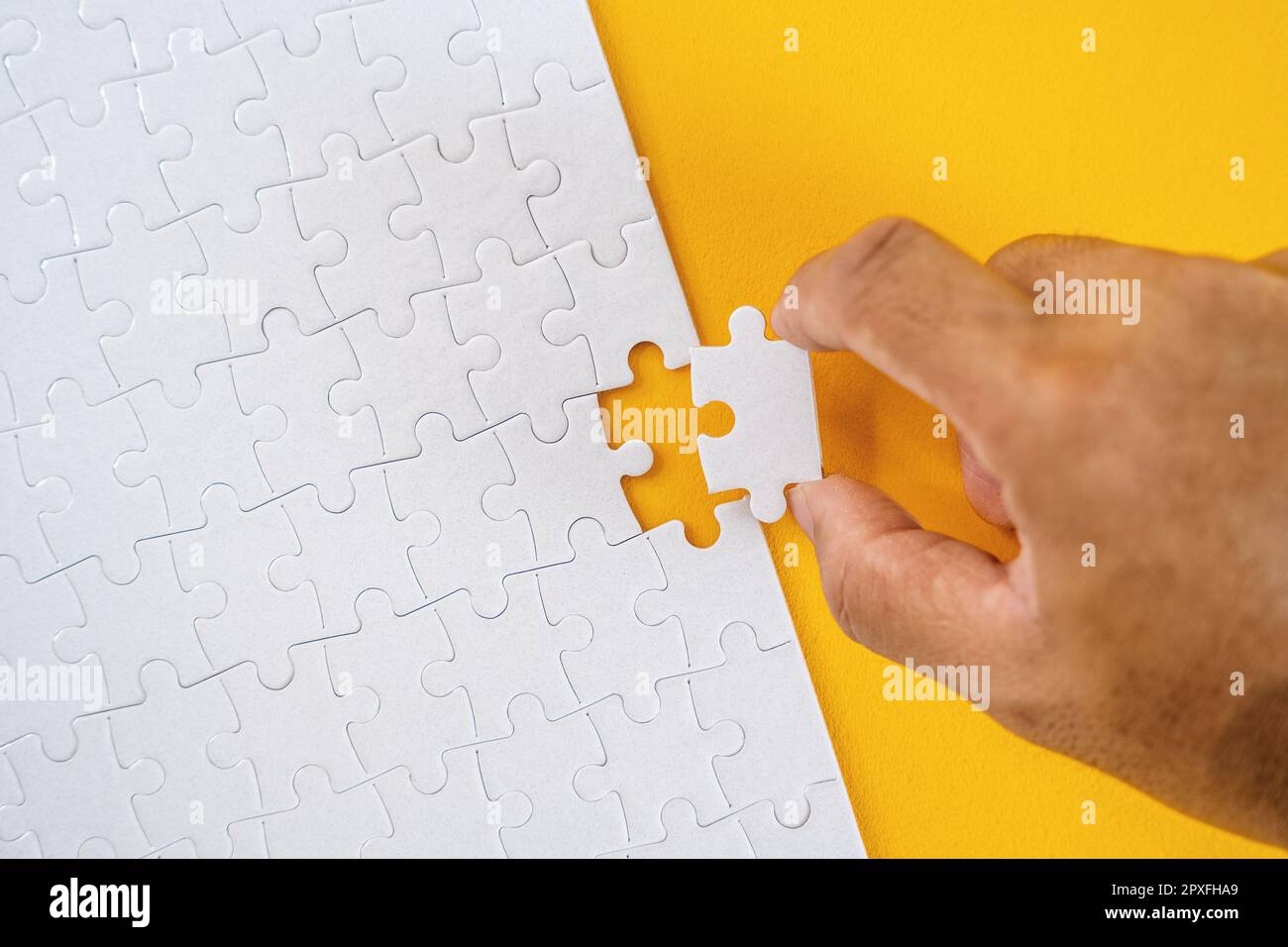 Hand Putting The Last Piece To Solve Jigsaw Puzzle Stock Photo - Alamy
