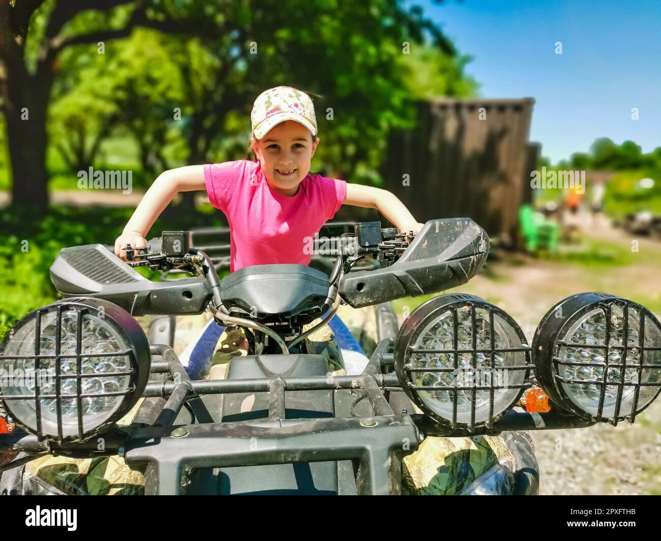 A child rides a quad bike through the mud. ATV rider rides Stock Photo ...