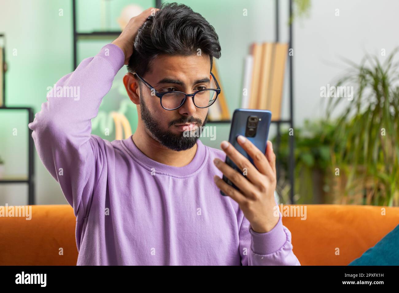 Sad Displeased Indian Man Use Smartphone Typing Browsing Loses
