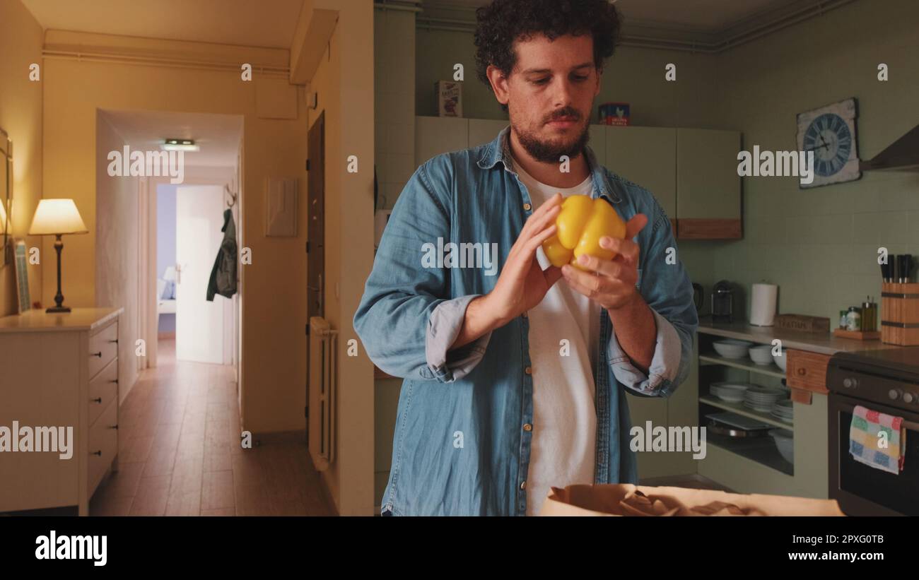 Guy dressed in denim shirt is returning home from the grocery store ...
