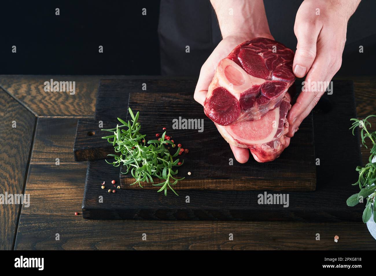 Chef cutting stack of beef meat from various or different steaks. Mans ...