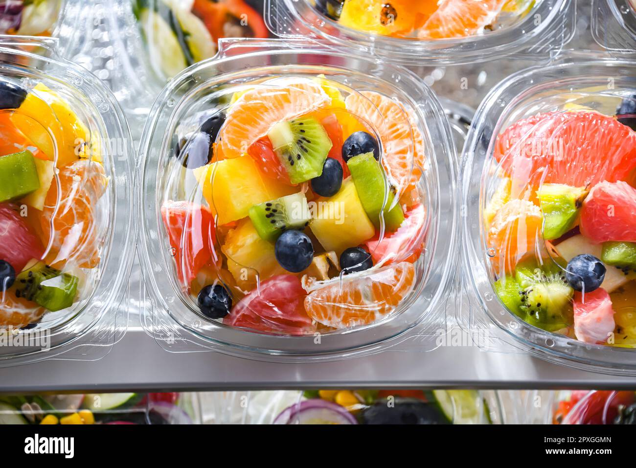 Plastic boxes with pre-packaged fruit salads, put up for sale in a ...