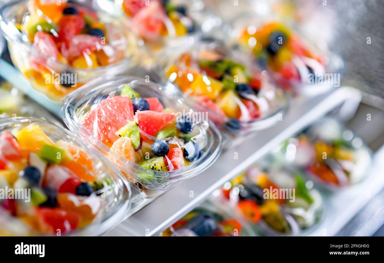 Plastic boxes with pre-packaged fruit salads, put up for sale in a ...