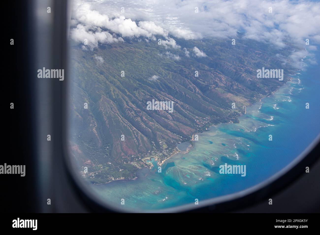 An aerial view of one of Hawaii's islands, as seen through the window ...
