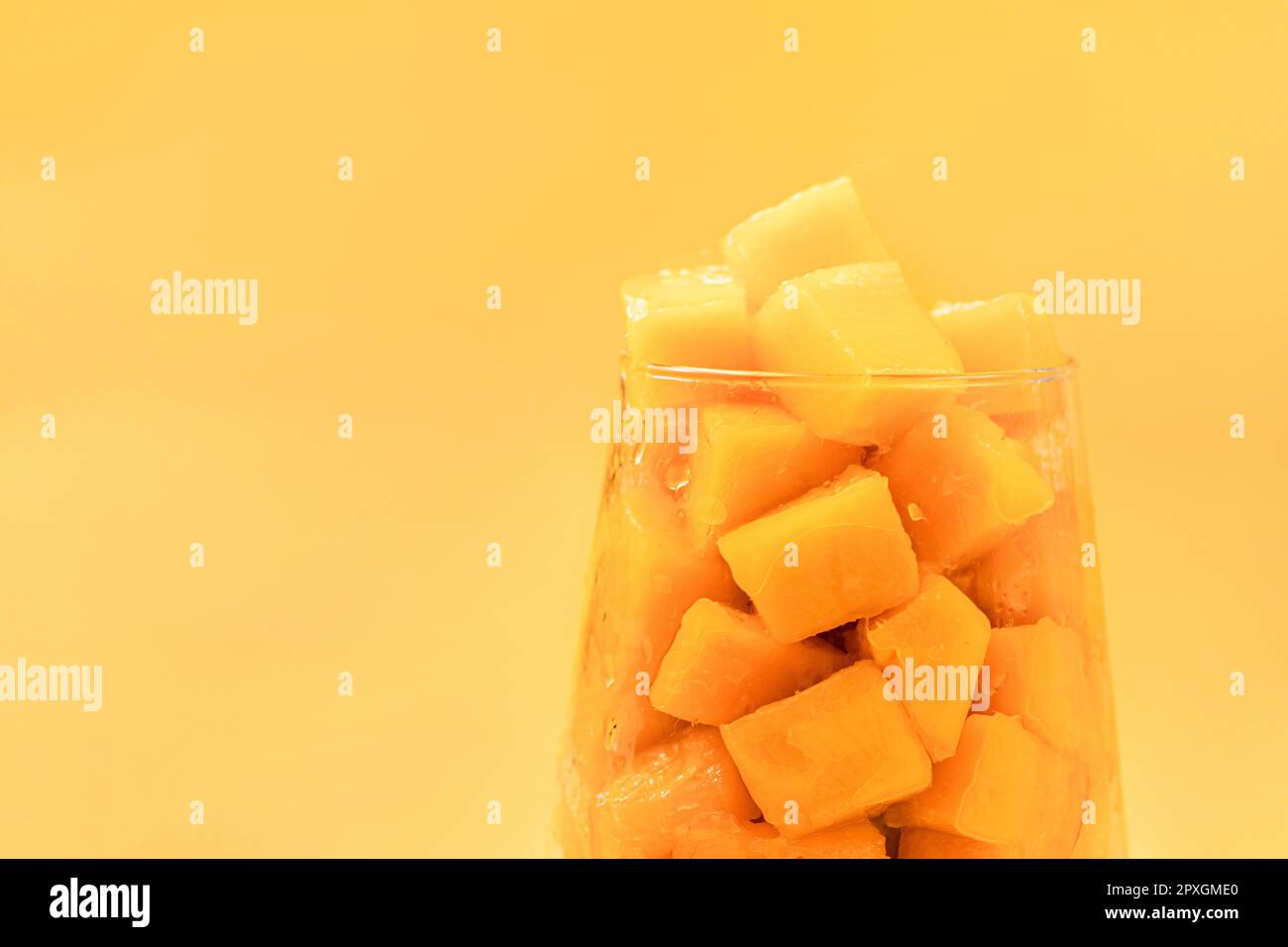 Glasses filled with mango pulp sit on a yellow background Stock Photo ...