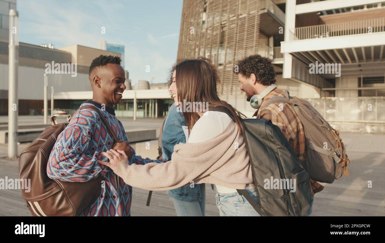 Group of students are chatting while standing outside. Cheerful ...