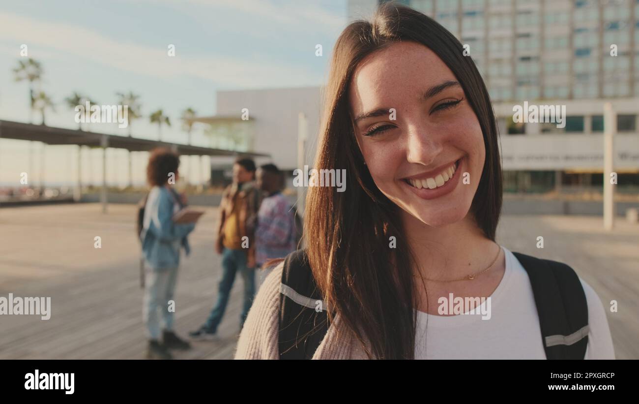 Girl is smiling while looking at the camera. Student with notebooks in ...