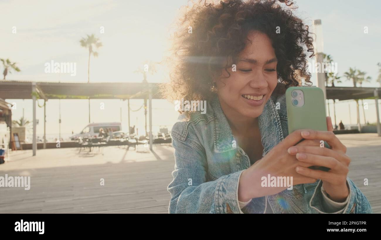 Girl takes a photo of friends on a mobile phone, Backlighting Stock ...