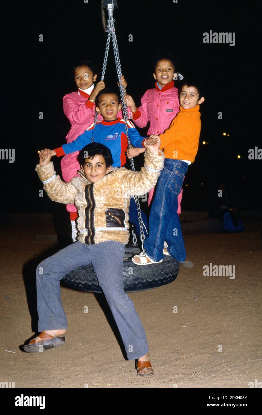 Saudi Arabia Portrait of Children in the Playground at Night playing on ...