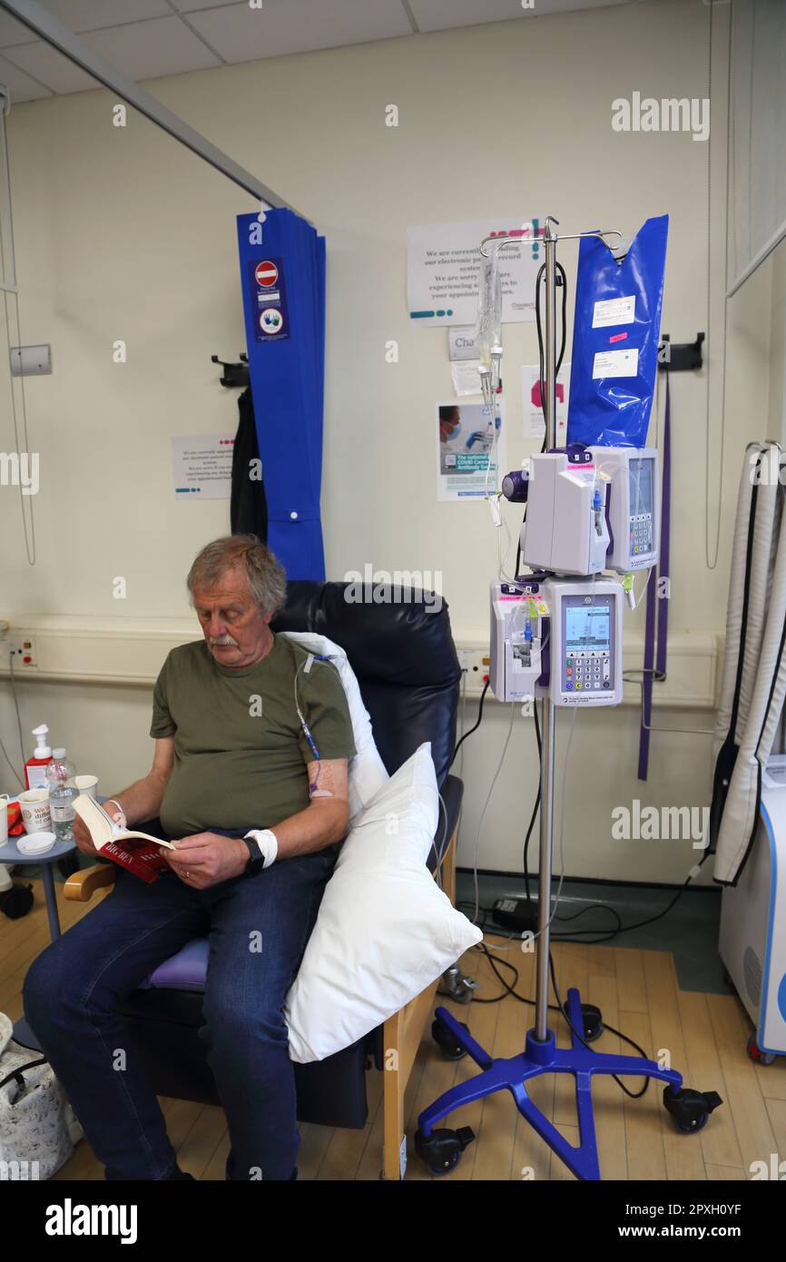 Cancer Patient Reading Book whilst having Chemotherapy Treatment with ...