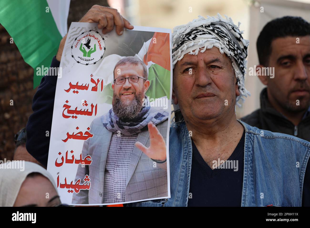 Nablus. 2nd May, 2023. A man holds a portrait of Khader Adnan during a ...