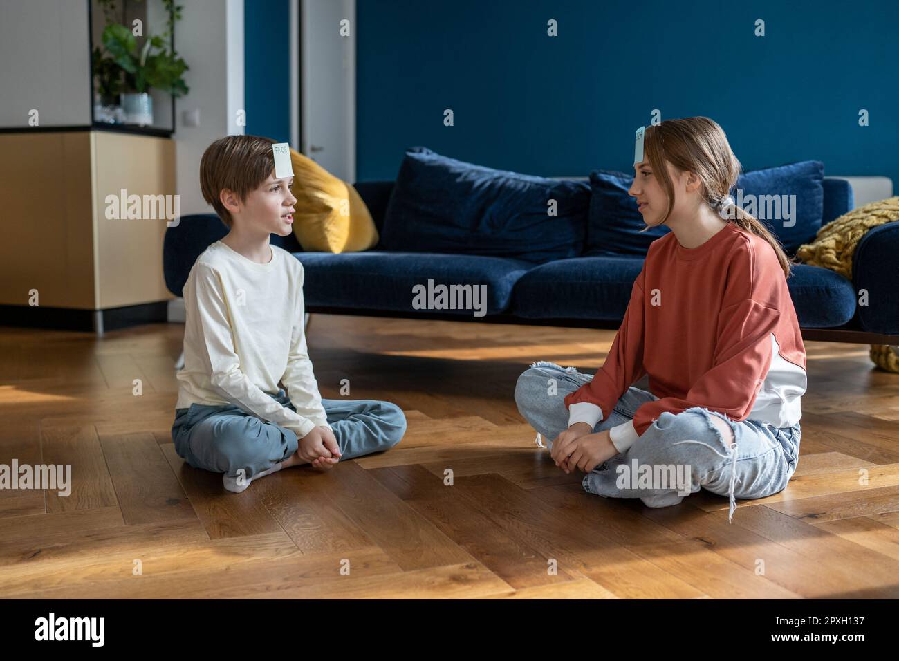 Children boy and girl siblings playing Who Am I guessing game while ...