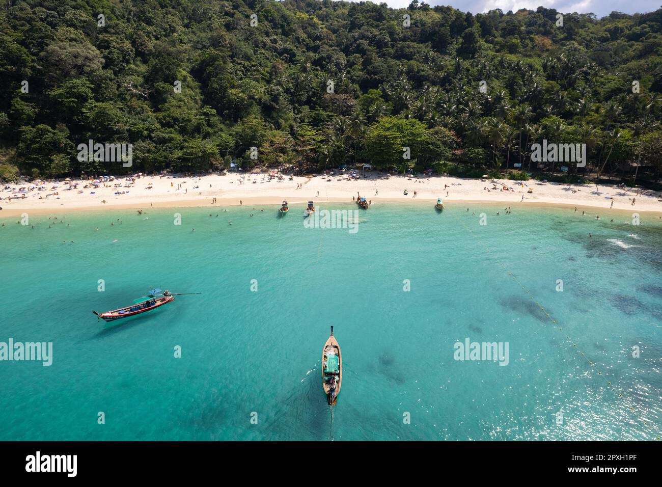 An aerial view of Freedom Beach in Phuket, surrounded by lush tropical ...