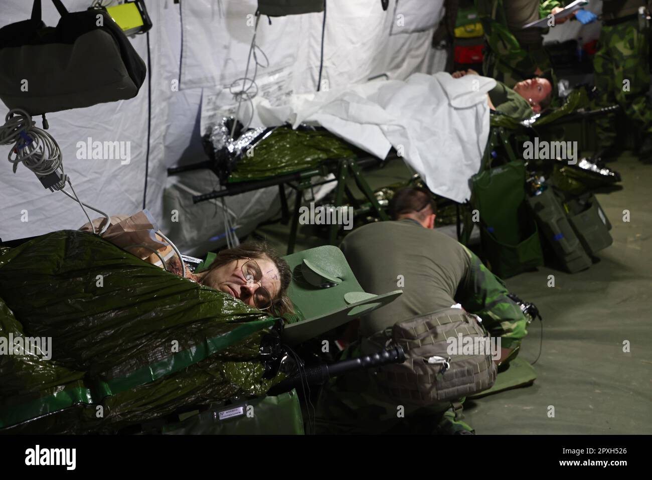 Patients and medical staff inside a field hospital during the large ...