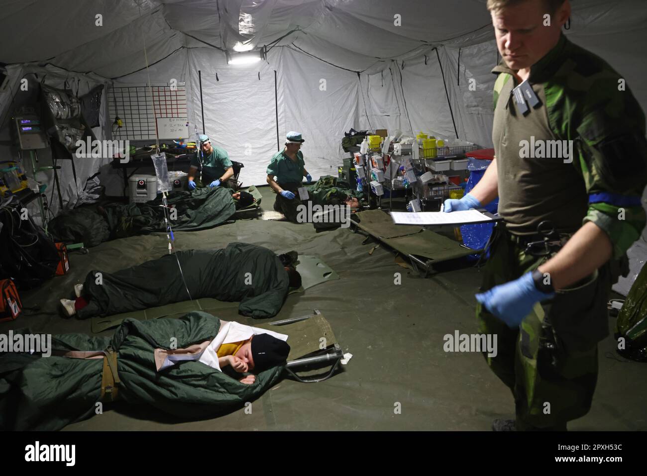 Patients and medical staff inside a field hospital during the large ...