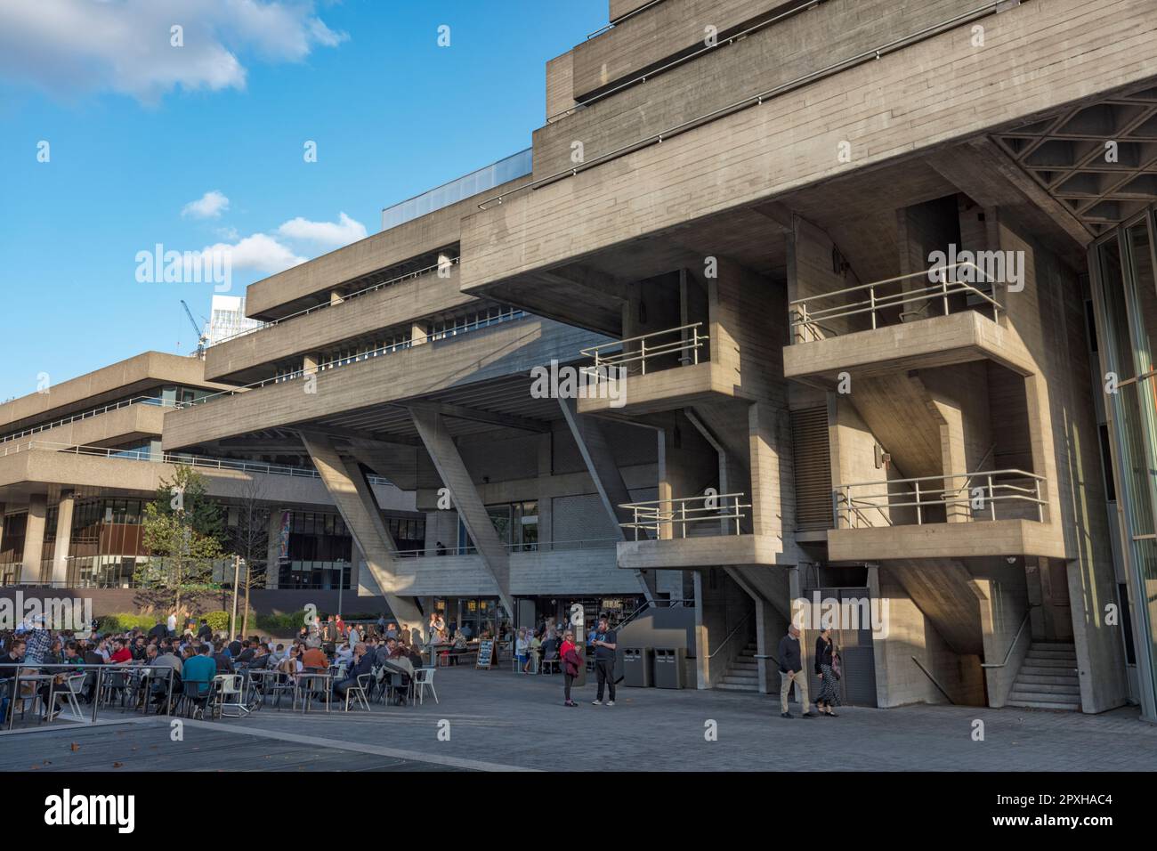 People at cafe, bar, restaurant outside National theatre brutalist ...