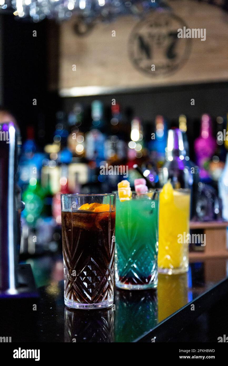 The three different cocktails. coke cocktail, blue cocktail, and yellow ...